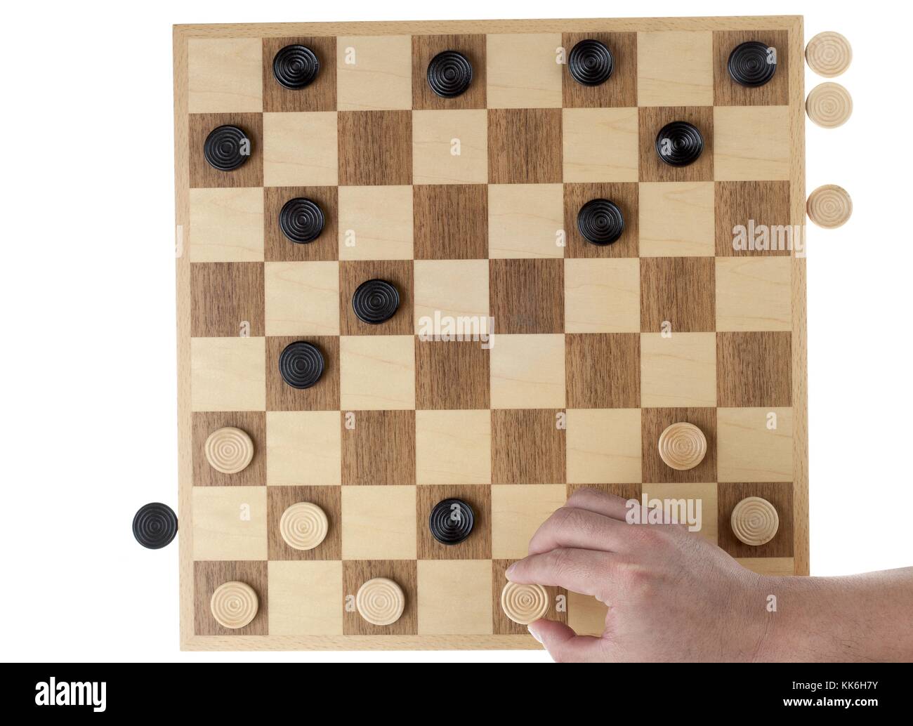 a hand playing on checker board Stock Photo - Alamy