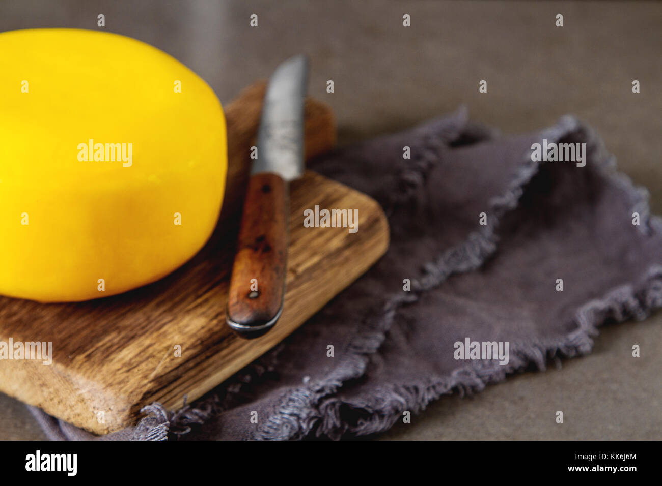 Round gouda cheese. Dark background Stock Photo - Alamy