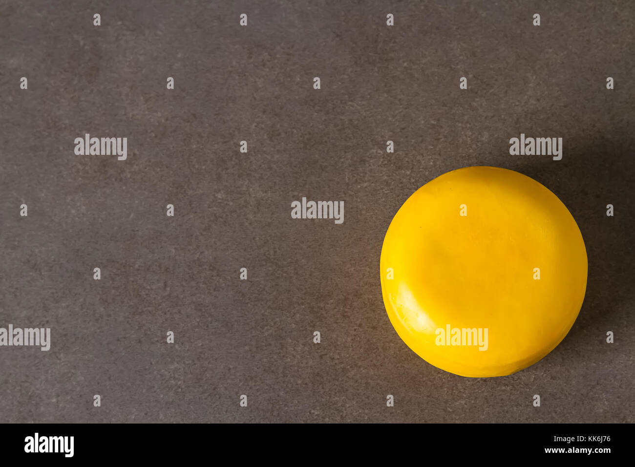 Round gouda cheese. Dark background Stock Photo - Alamy