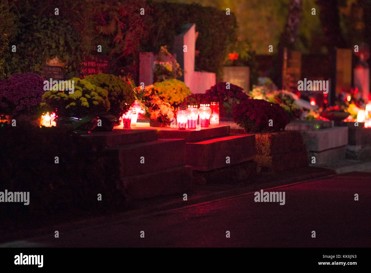 Burning candles on cemetery at night Stock Photo - Alamy
