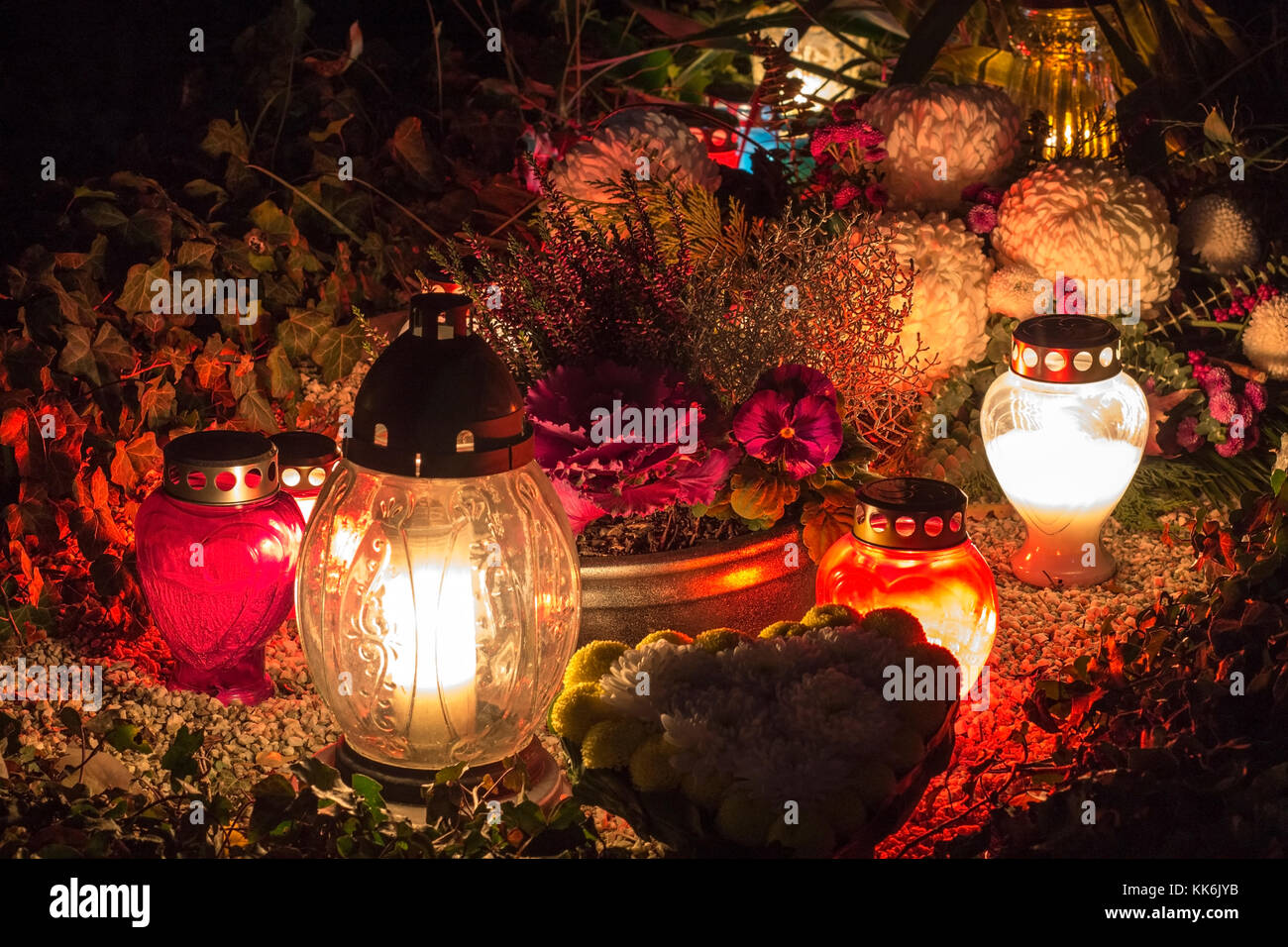 Burning candles on cemetery at night Stock Photo - Alamy