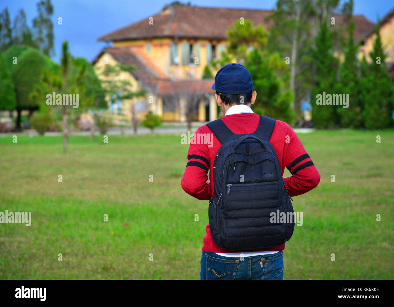 An Asian young man student walking at campus outdoors Stock Photo - Alamy