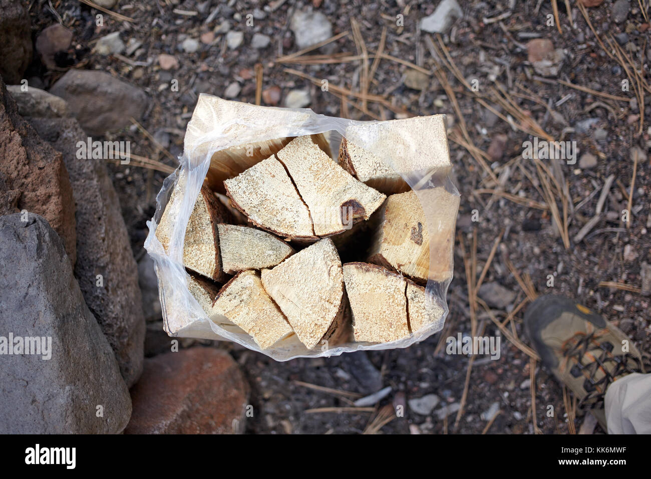 Small wrapped bundle of dried firewood for camping with chopped and ...