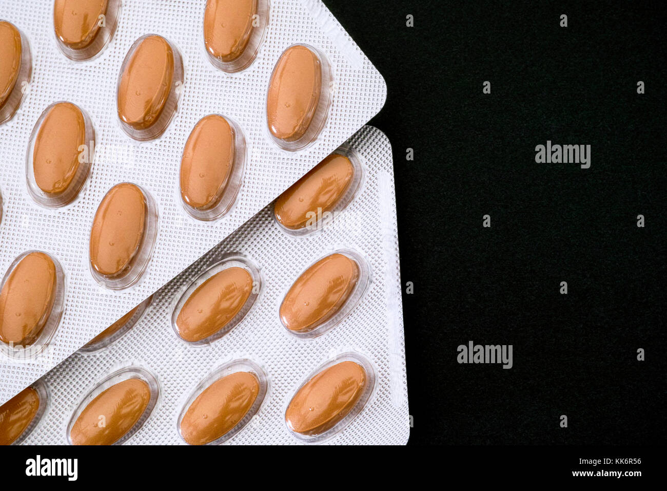 Two blisters with medicine pills on black background. Close-up Stock ...
