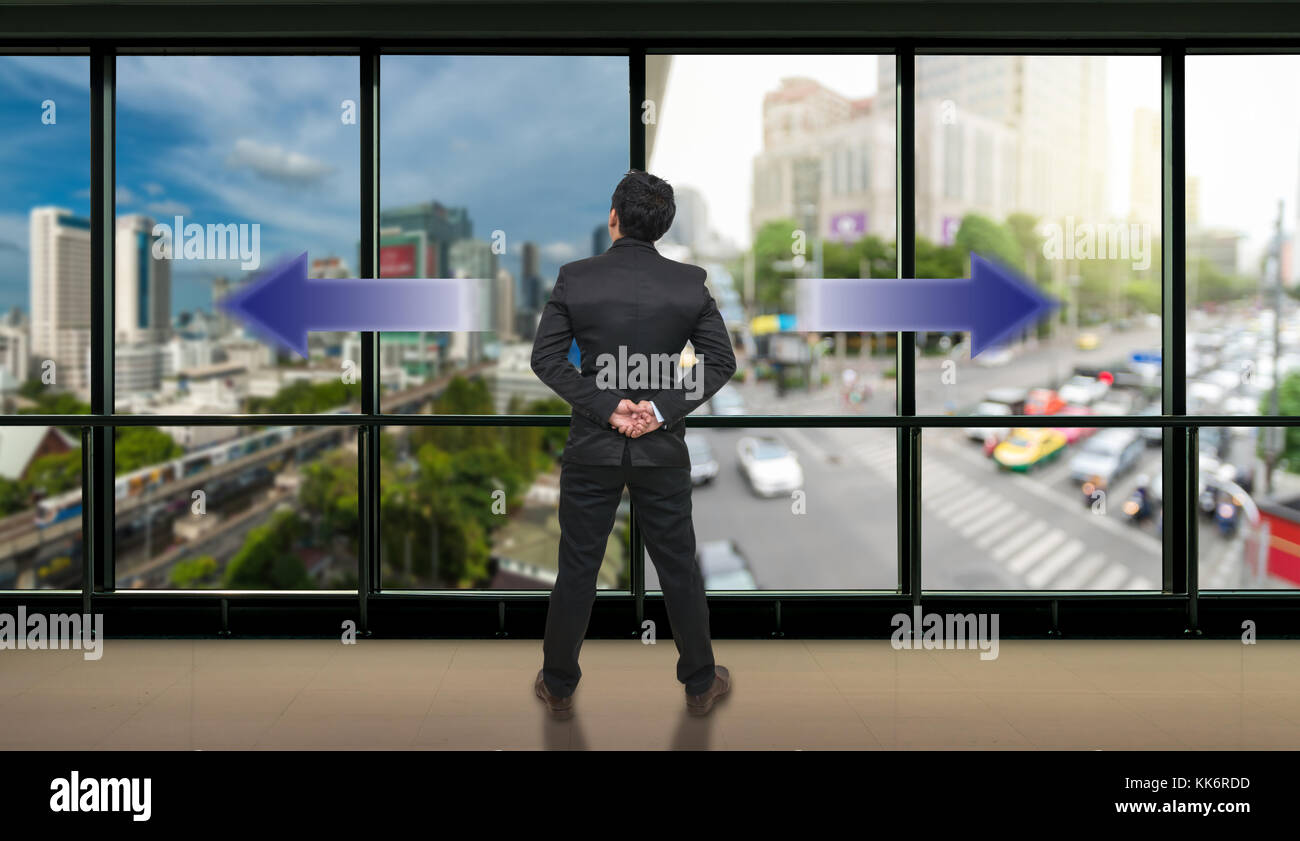 Businessman standing in doubt,thinking the two different choices of ... Businessman standing in doubt,thinking the two different choices of ...