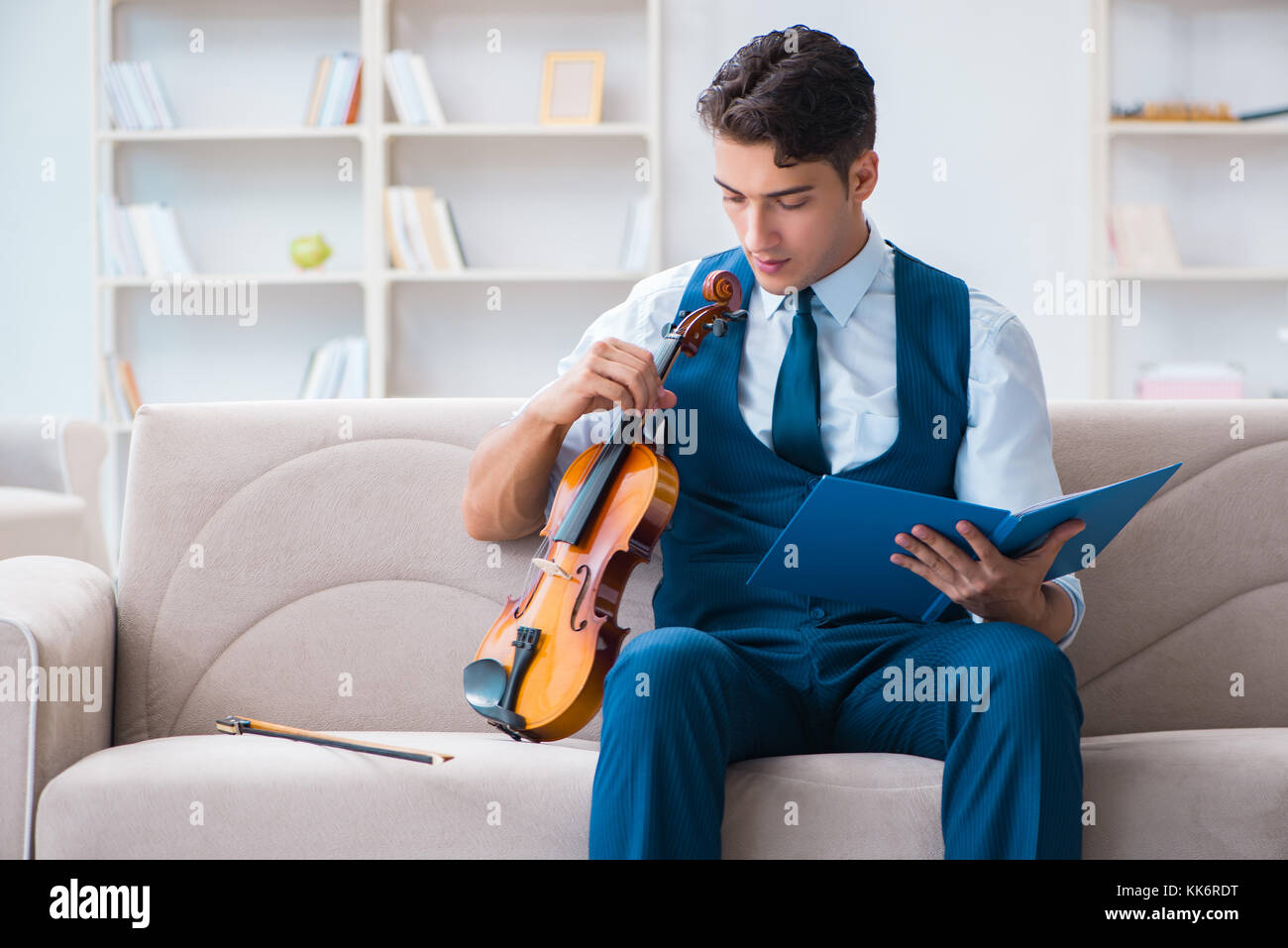 Young musician man practicing playing violin at home Stock Photo - Alamy