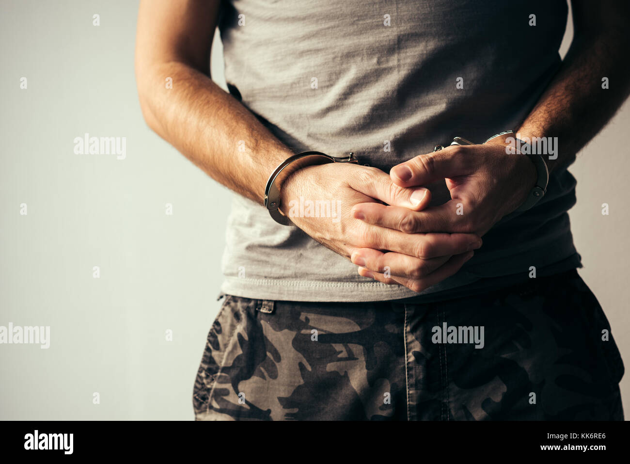 Handcuffed soldier in military army clothes. Prisoner of war or ...