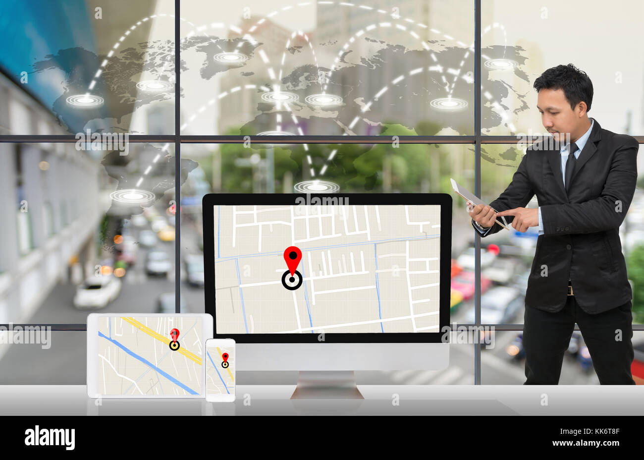 Asian Businessman using tablet with Computer set showing part of ...