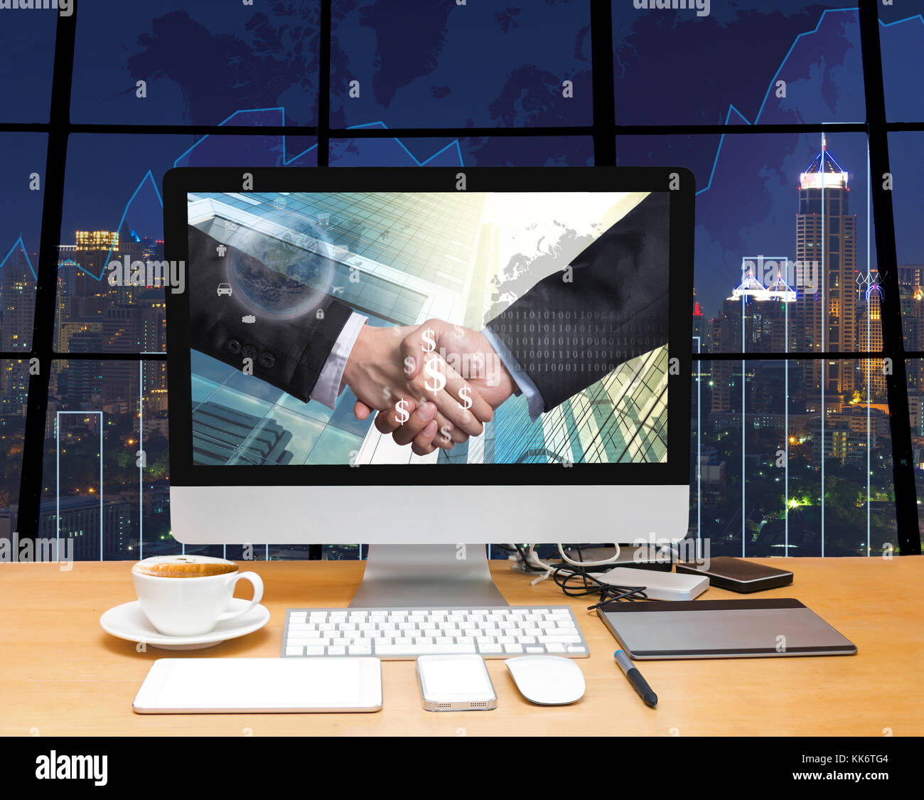 Workspace with computer desktop with Hand shake between businessman at ...