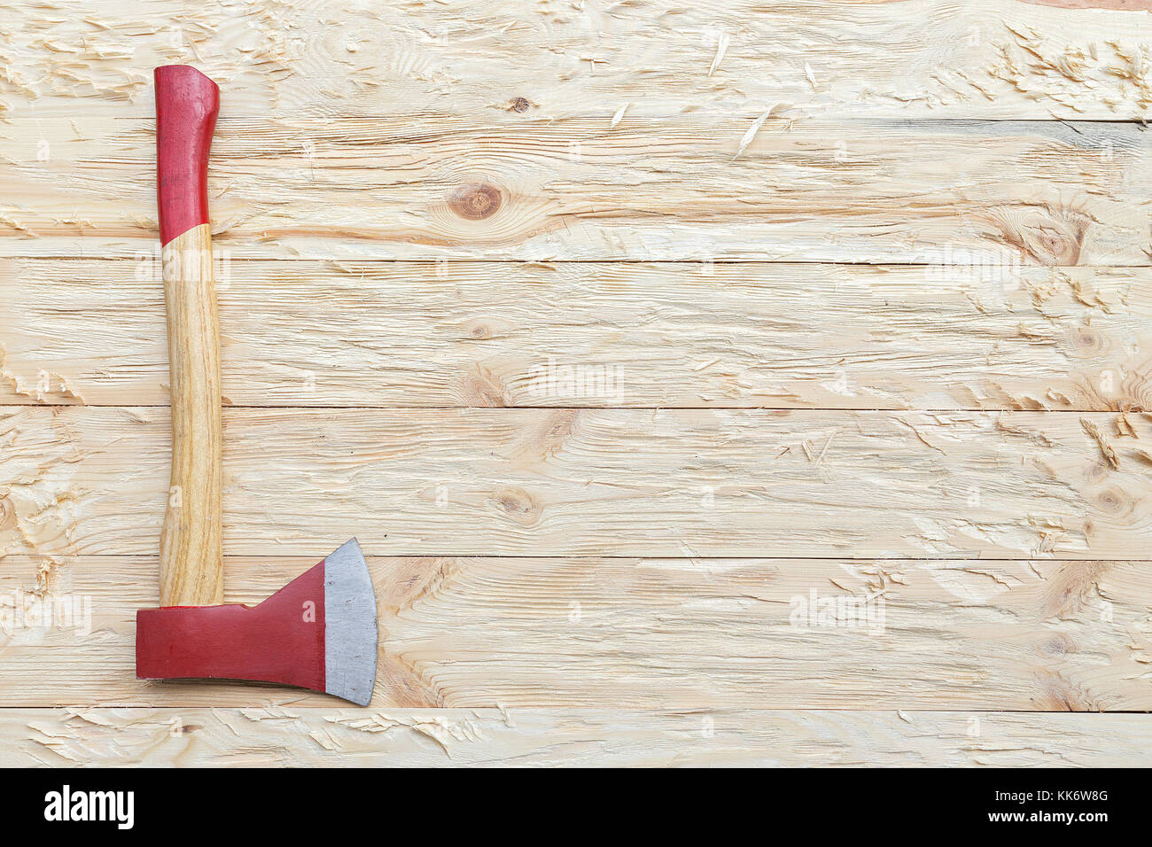 Red ax on a wooden background, top view Stock Photo - Alamy