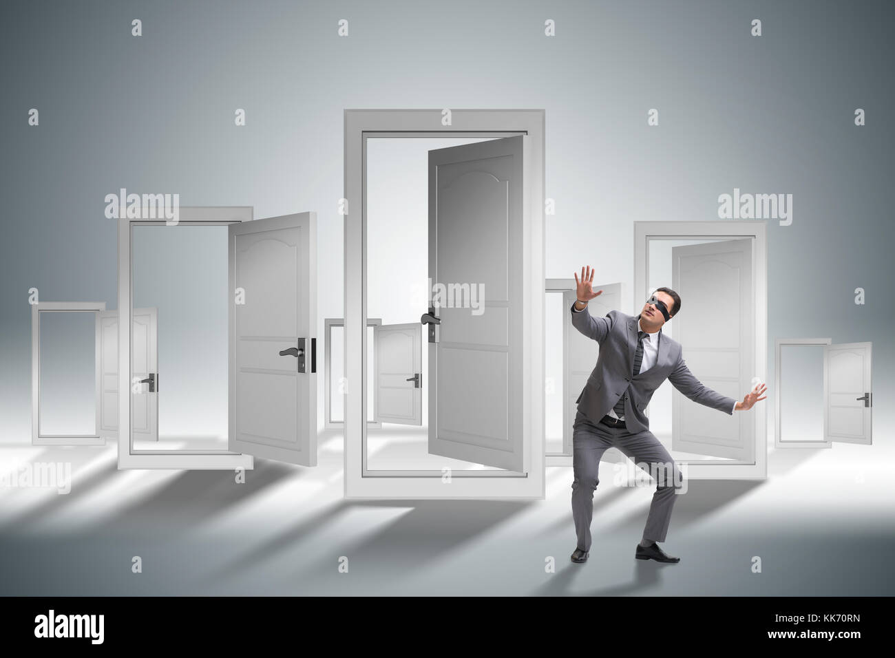 Confused businessman in front of doors Stock Photo - Alamy