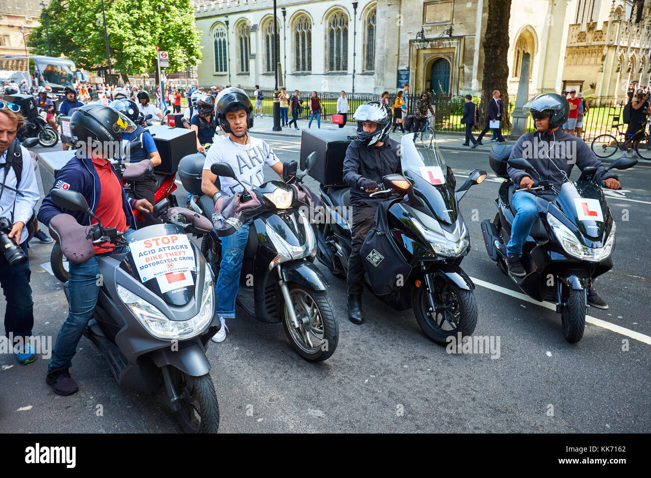 Moped riders, including couriers and delivery drivers, protest in ...