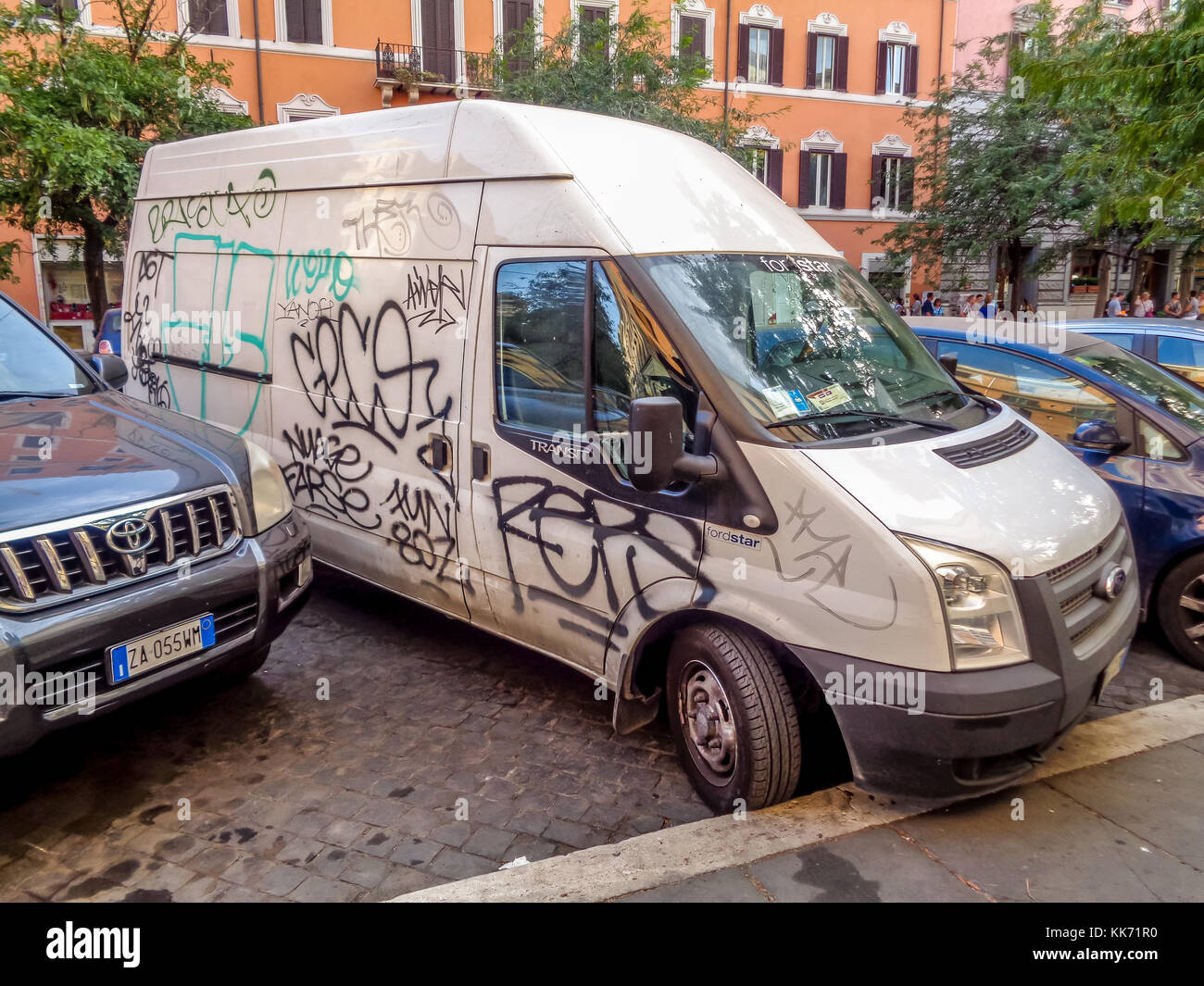 A graffitti covered Ford transit Van on Via Carlo Alberto, Rome, Italy ...