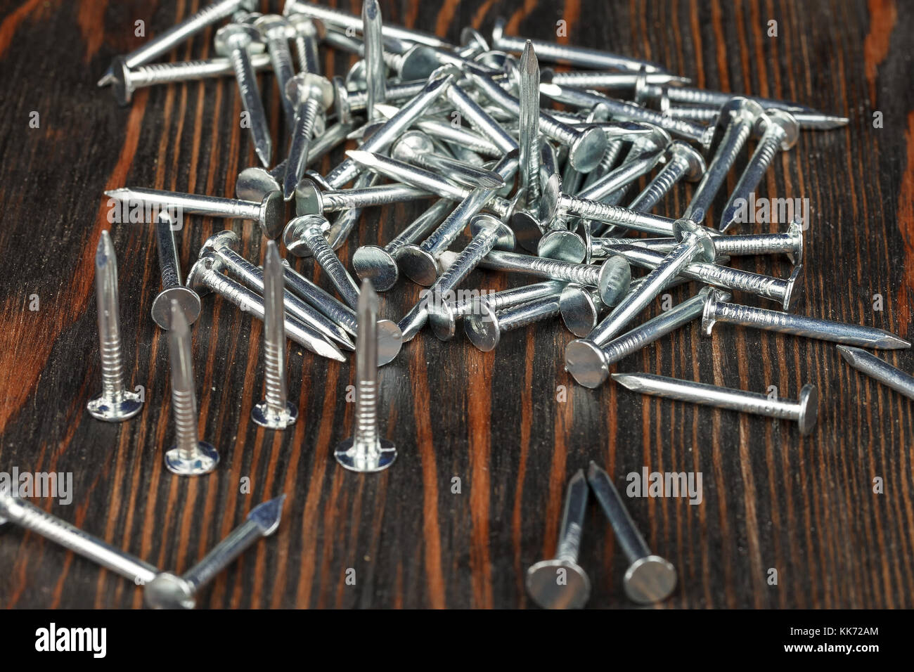 Construction nails on a wooden surface. Close-up. Studio lighting Stock ...