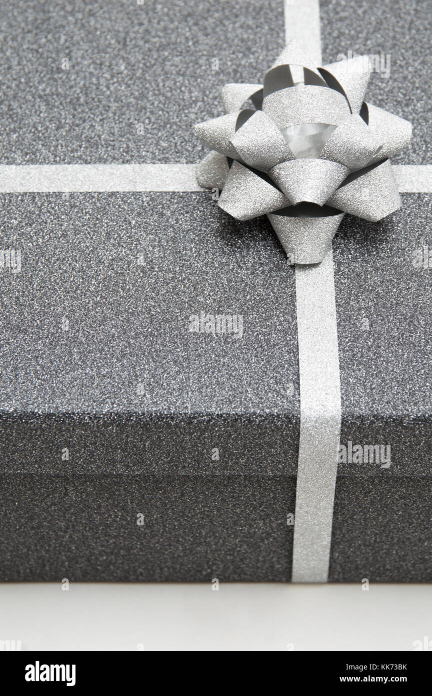 Black gift box with silver ribbon on white background Stock Photo - Alamy