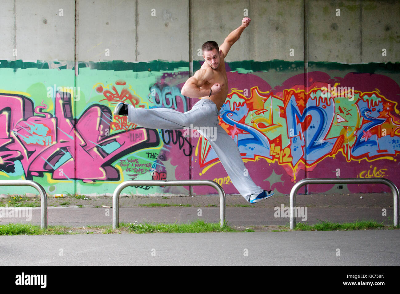 Young muscular man jumping in an outdoor location Stock Photo - Alamy