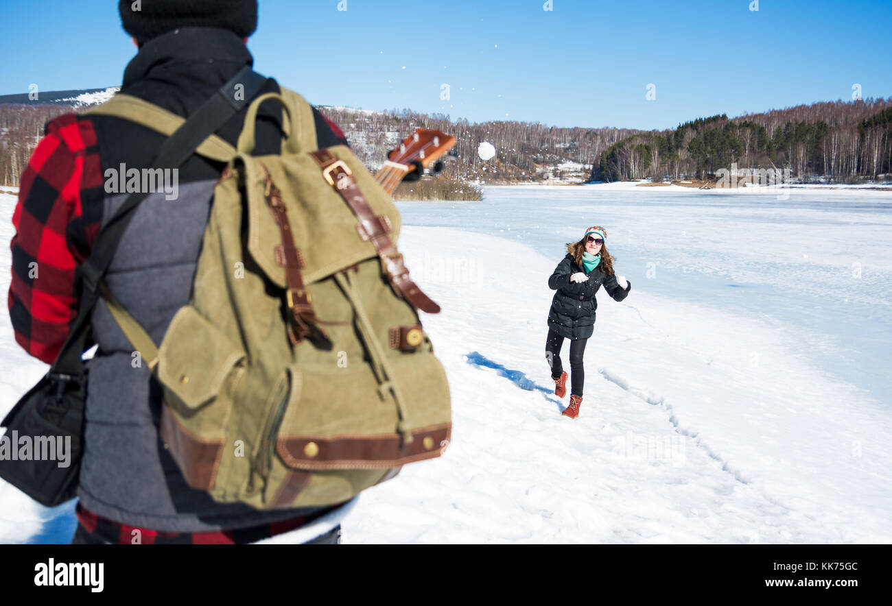 Couple having a snowball fight on a sunny winter day Stock Photo - Alamy