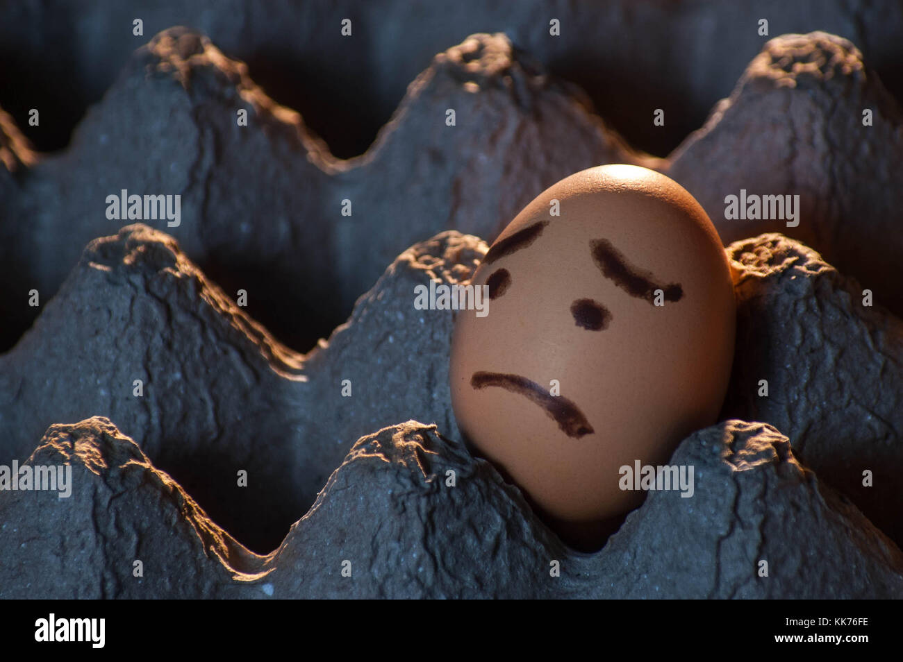 Close-up horizontal image of an egg with a sad face painted on it Stock ...