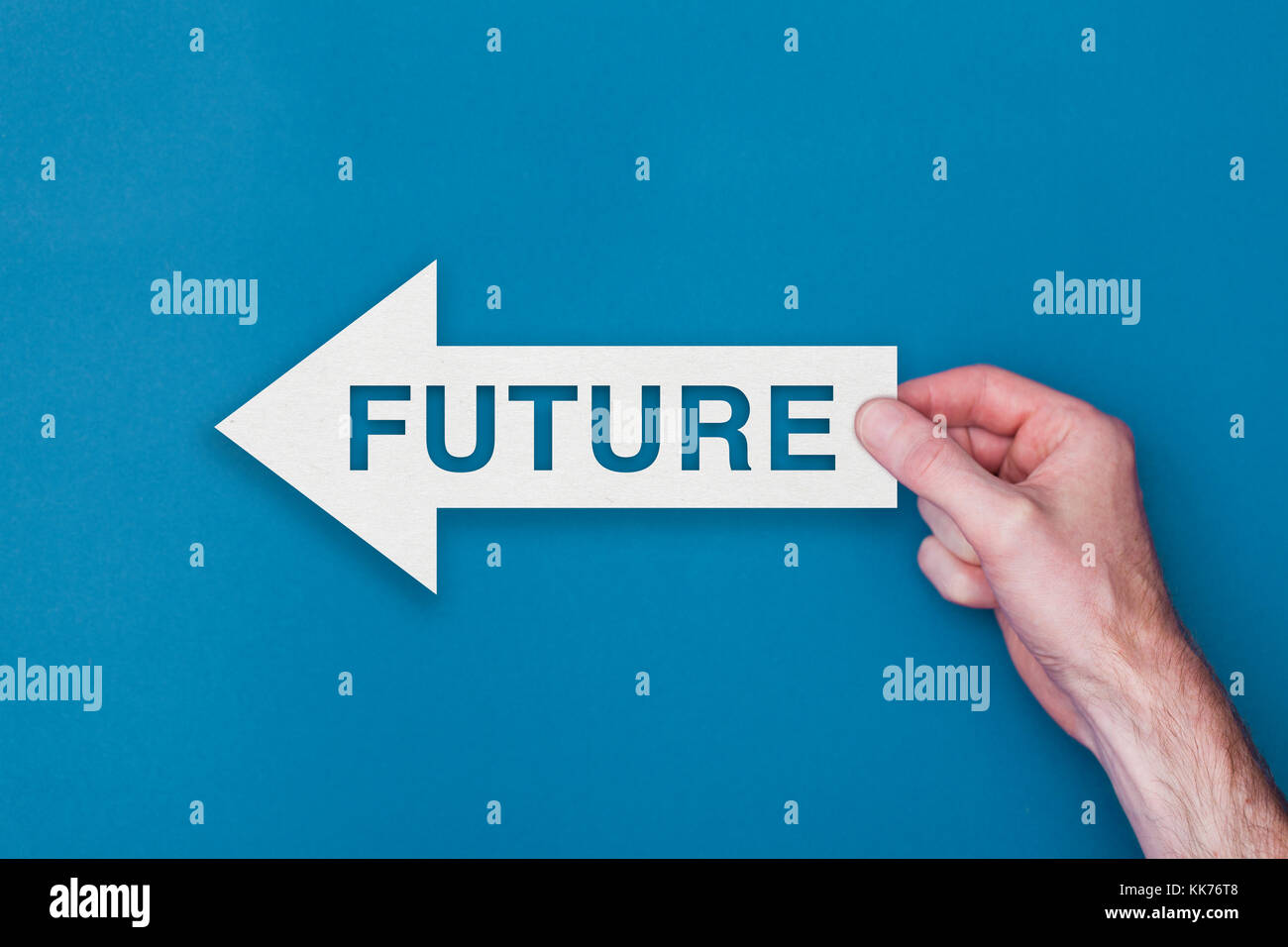 Future arrow direction held on a blue background Stock Photo - Alamy