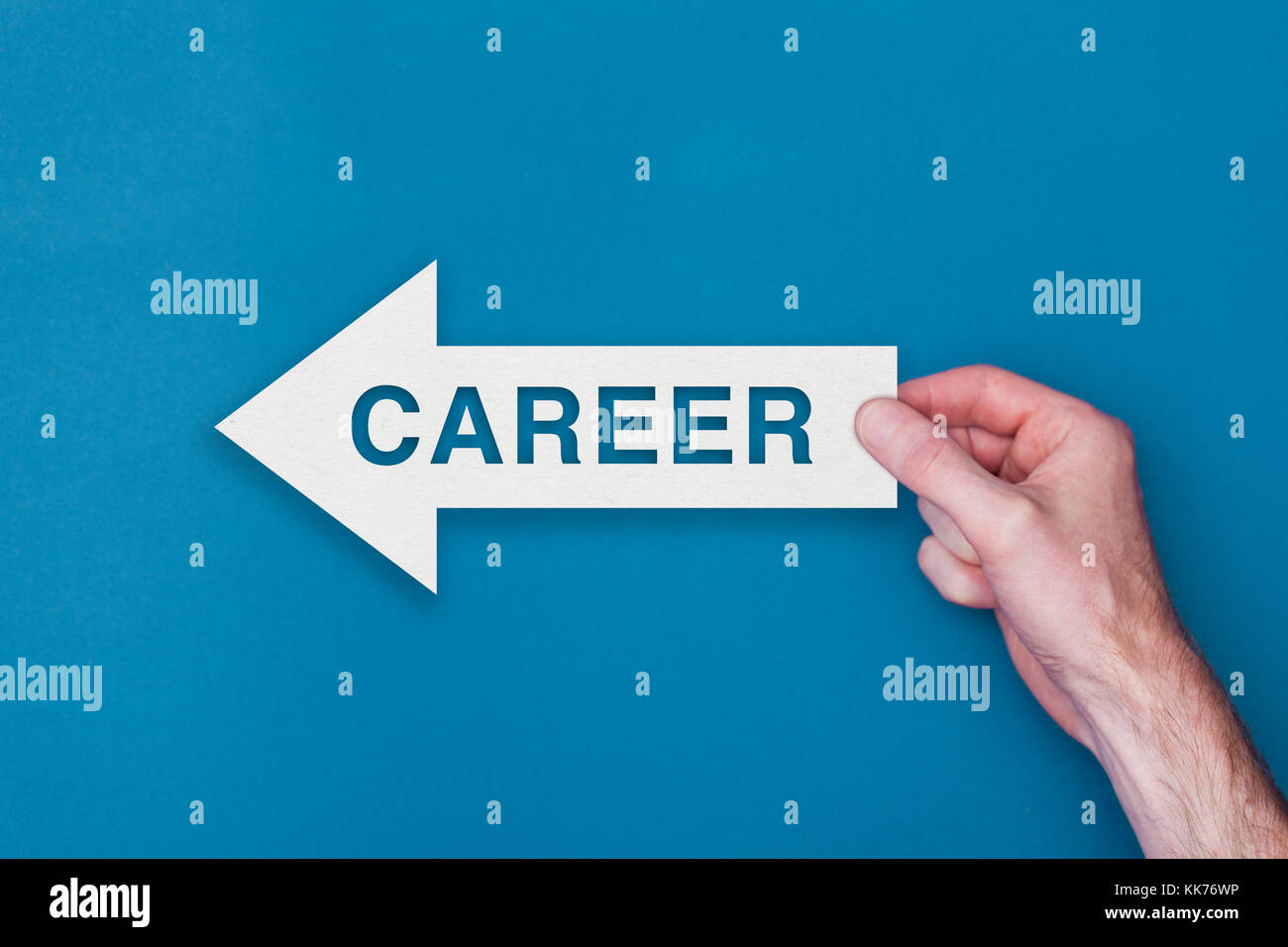 Career arrow direction held on a blue background Stock Photo - Alamy