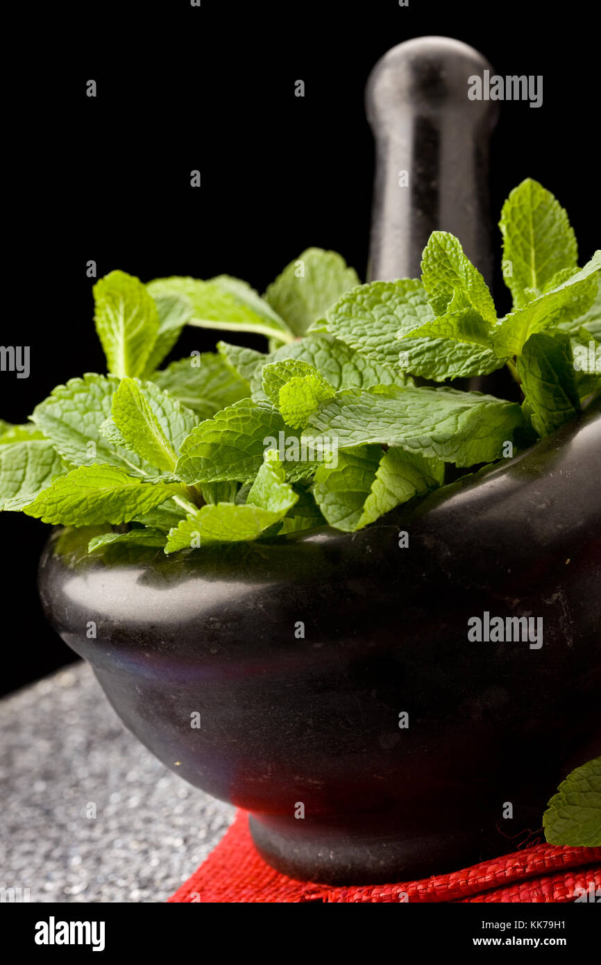 photo of fresh aromatic mint in mortar on a glass table Stock Photo - Alamy