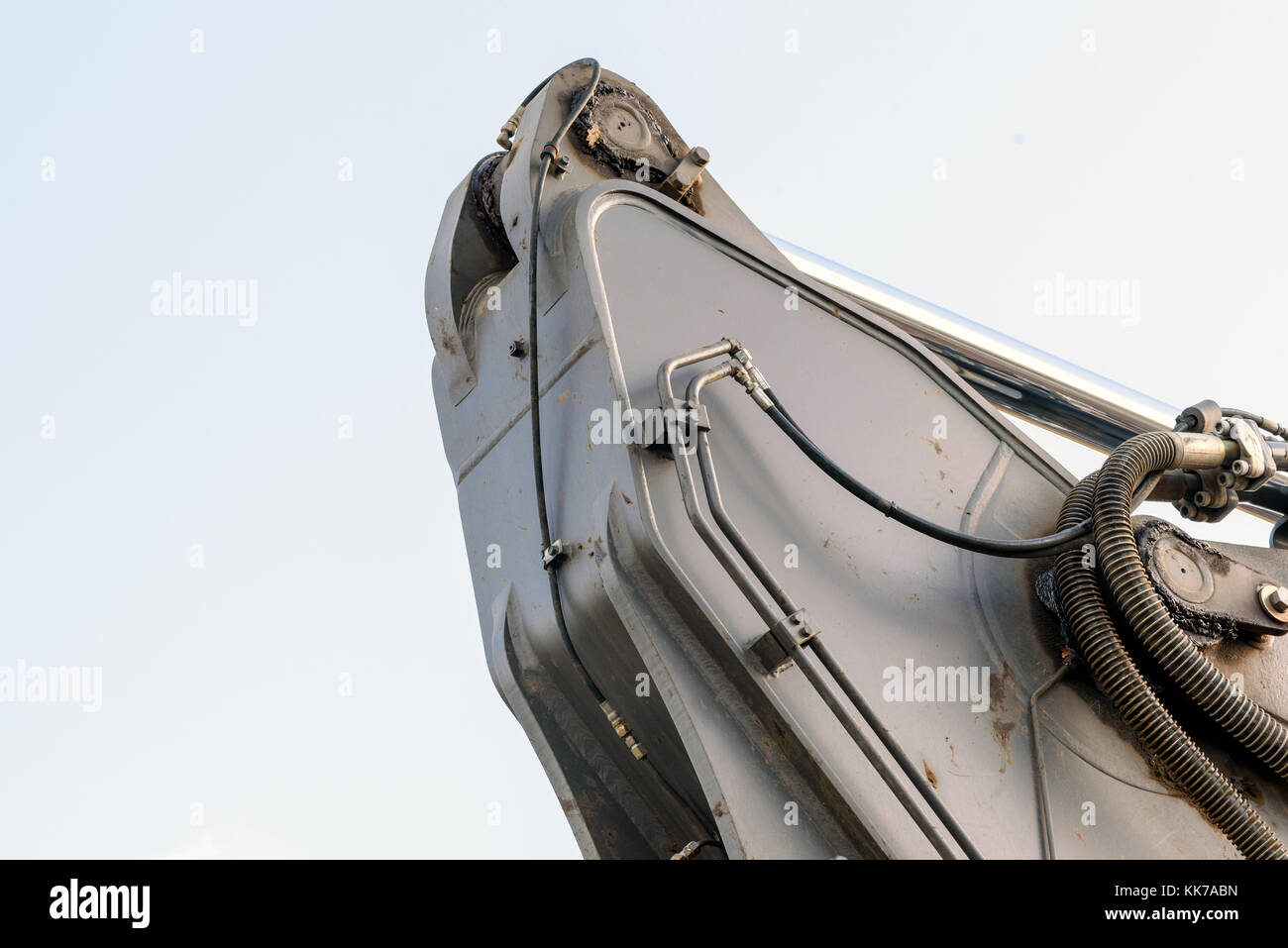 Black hydraulic arm of a digger excavator earthmoving machine with a ...