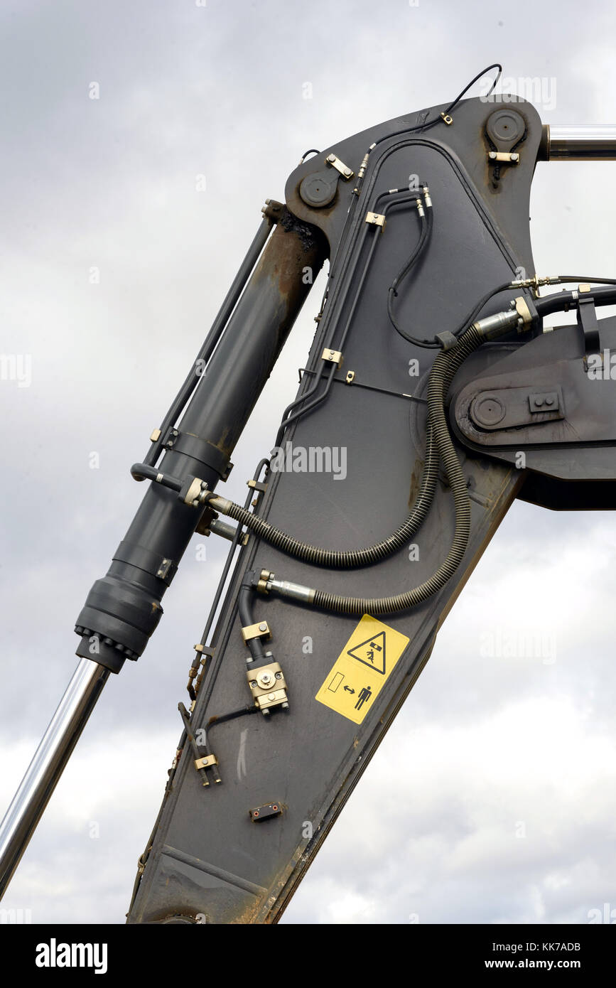 Black hydraulic arm of a digger excavator earthmoving machine with a ...