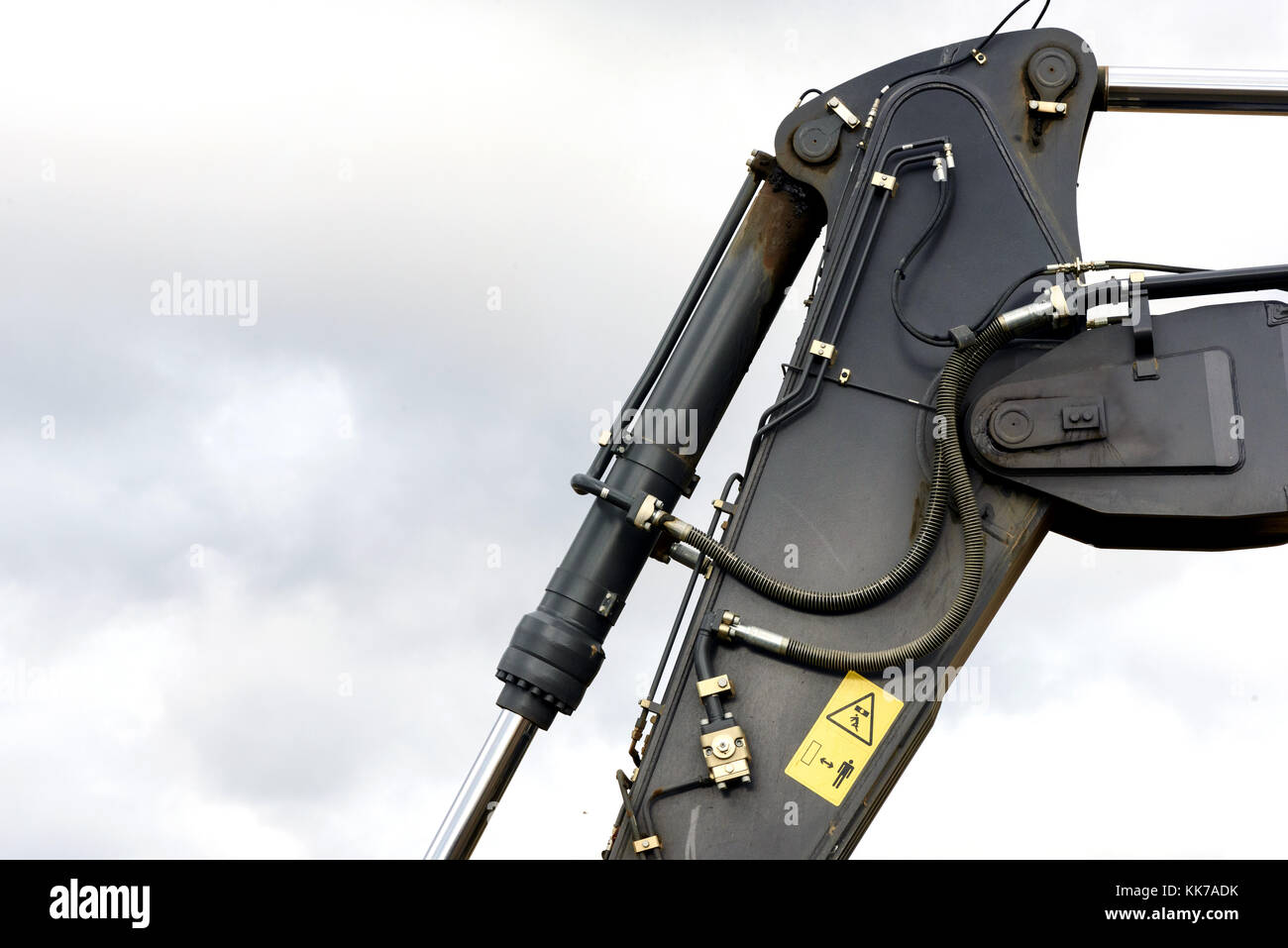Black hydraulic arm of a digger excavator earthmoving machine with a ...