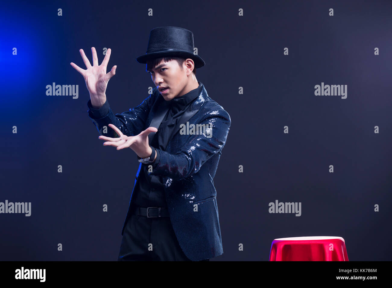 Young Chinese magician performing magic trick Stock Photo - Alamy