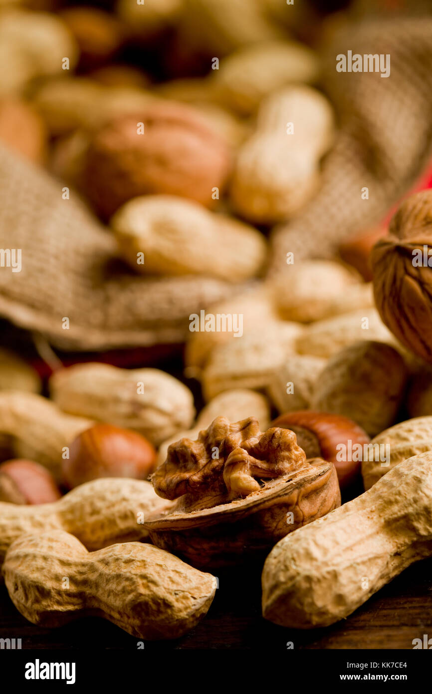 photo of differents nuts inside a cloth on wooden table Stock Photo - Alamy