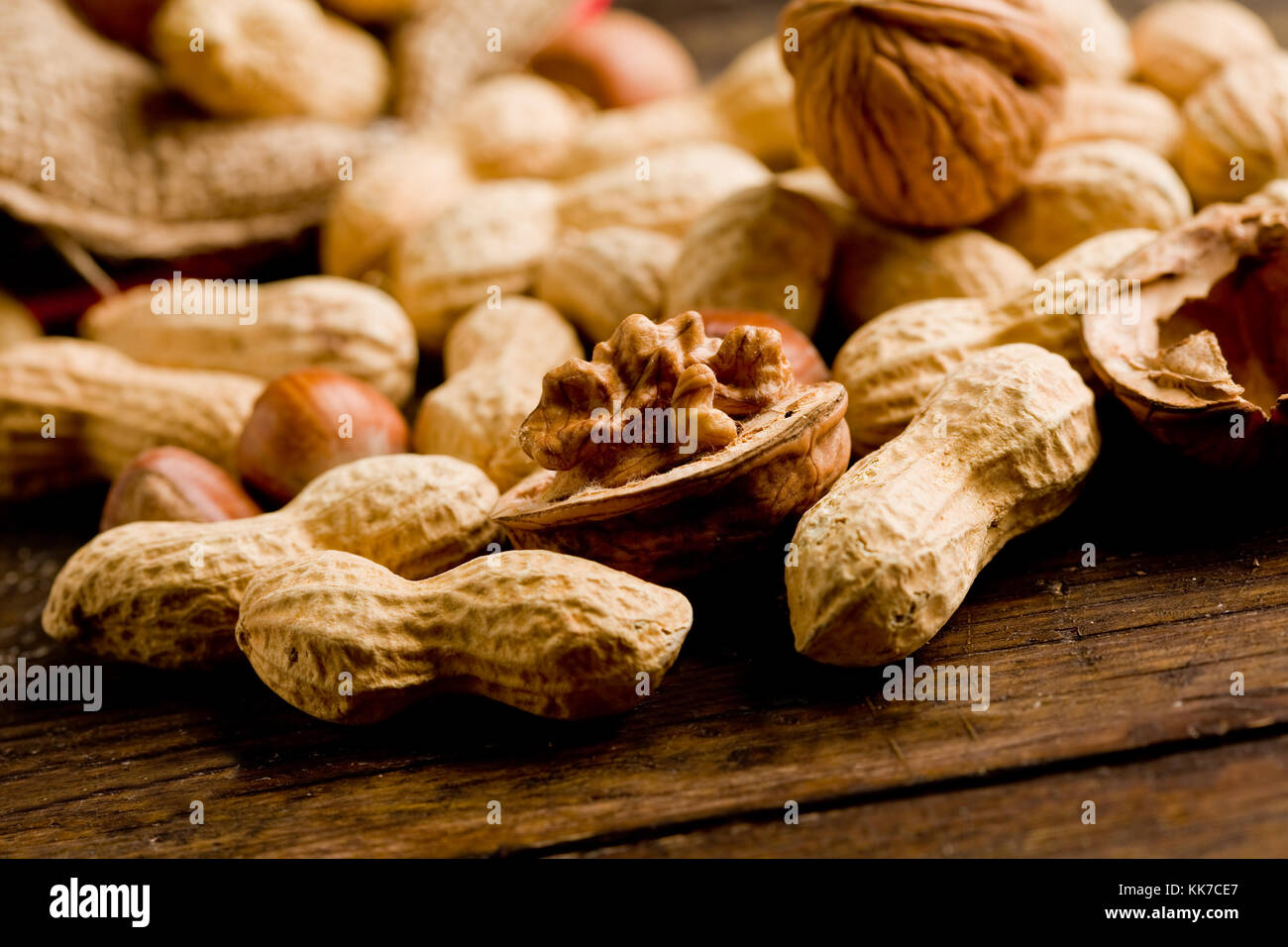 photo of differents nuts inside a cloth on wooden table Stock Photo - Alamy