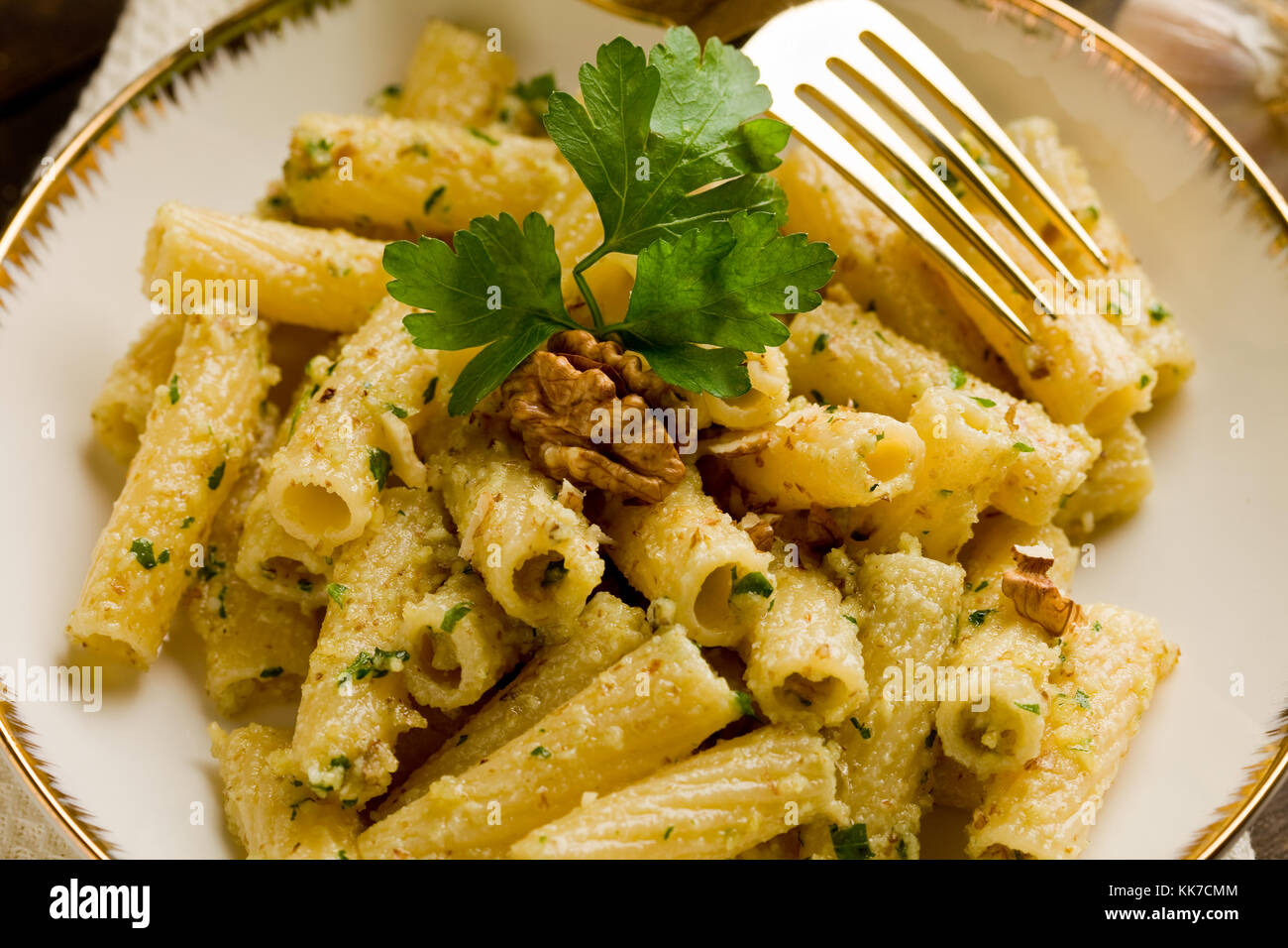 Italian regional dish made of pasta with walnut pesto on wooden table ...