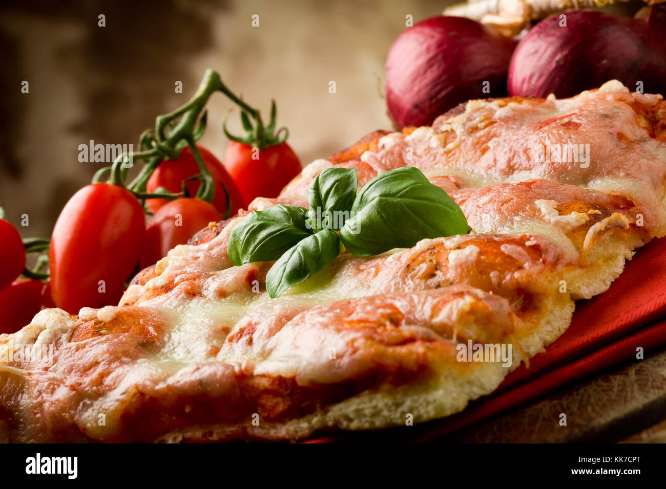 photo of delicious slice of pizza with basil leaf on it Stock Photo - Alamy