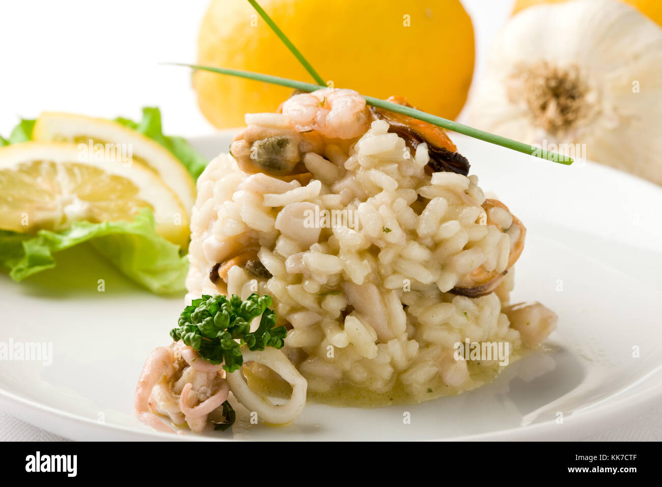 photo of delicious risotto with seafood on white isolated background ...