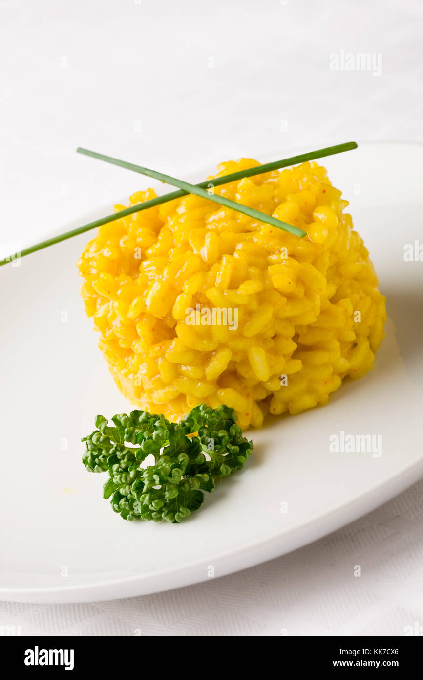 photo of delicious yellow risotto with saffron on white isolated ...