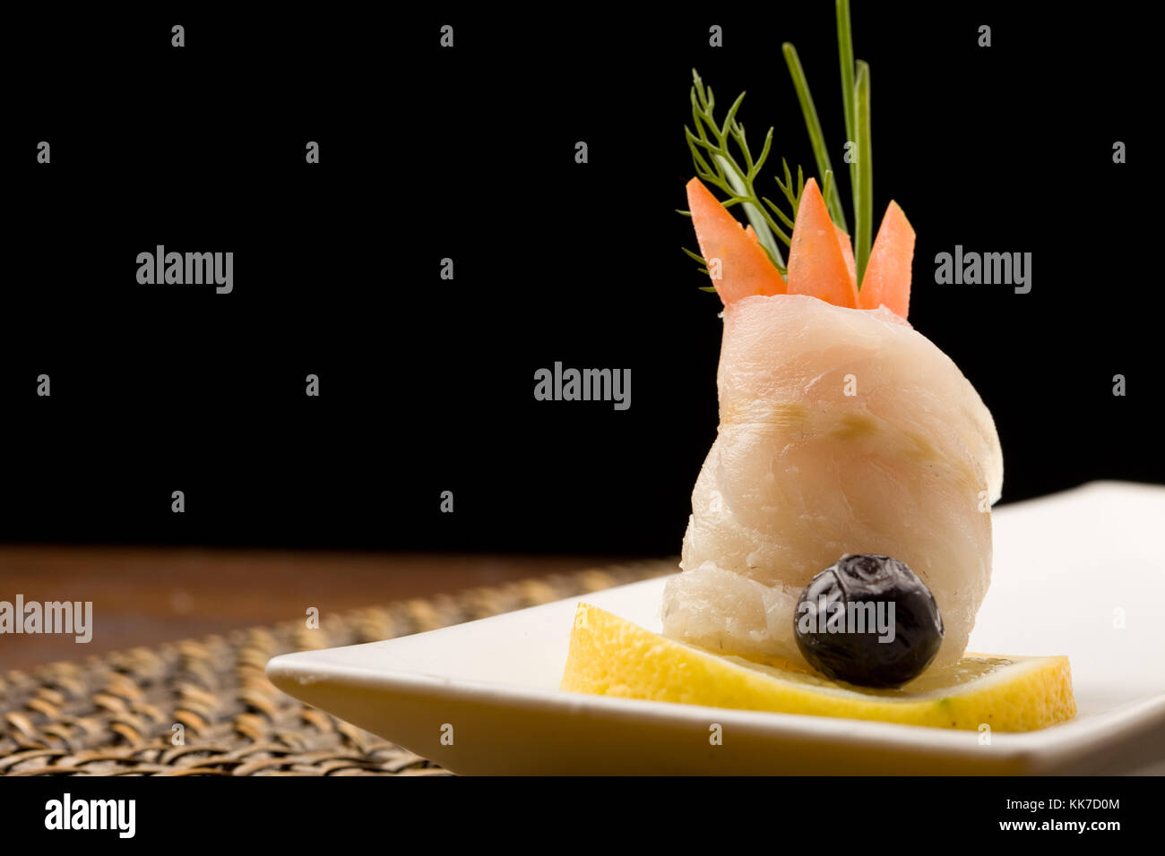 photo of delicious sea bass rolls with cutted tomatoes inside Stock ...