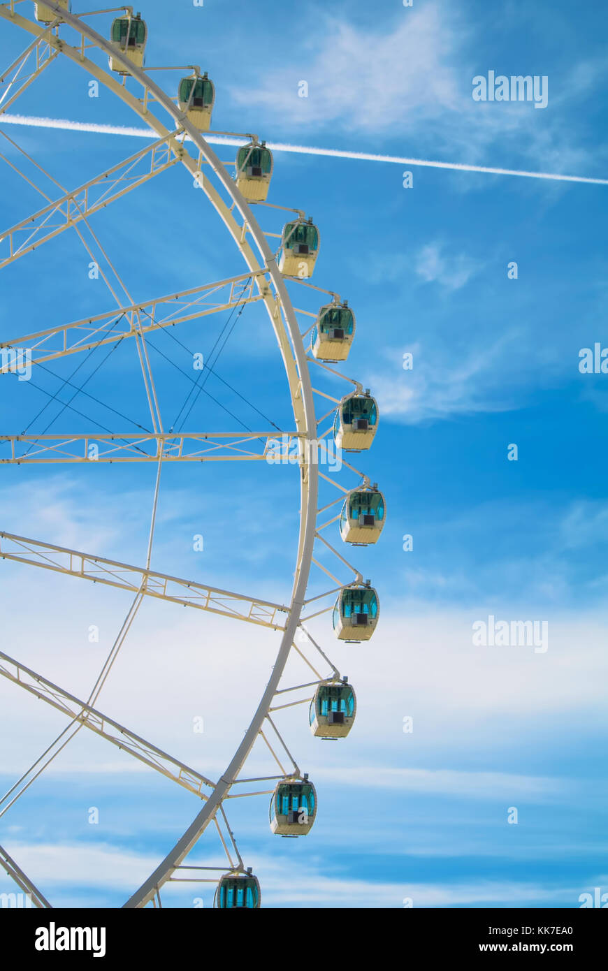 White beautiful modern ferris wheel with blue sky at the background ...