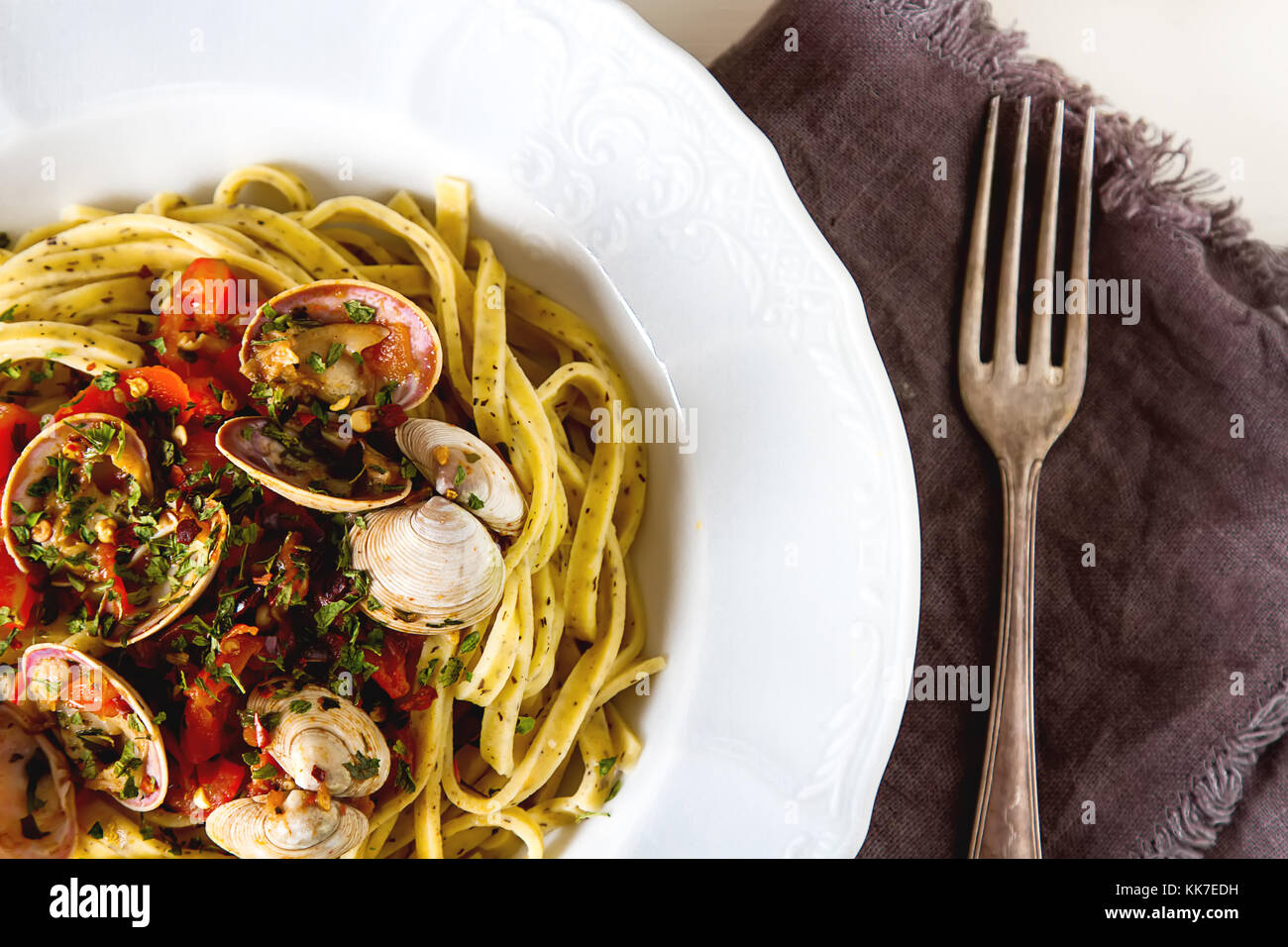Italian tagliatelle in a restaurant with mussels and tomatoes. Dark ...