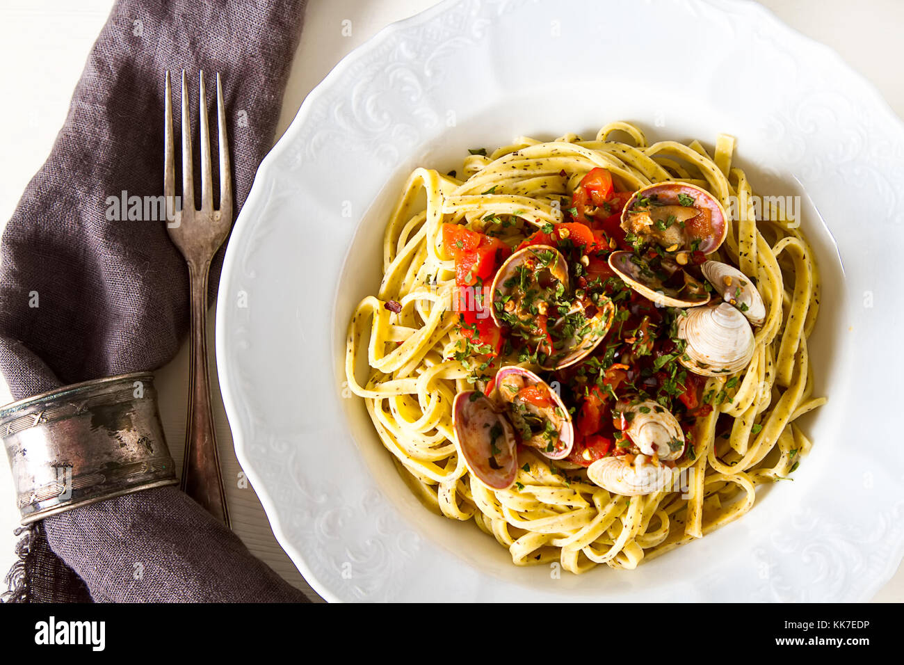 Italian tagliatelle in a restaurant with mussels and tomatoes. Dark ...