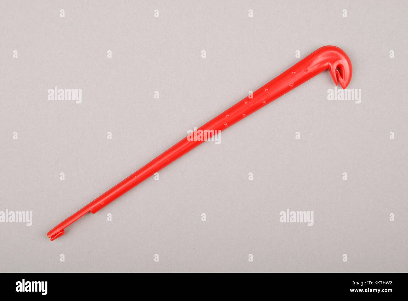 One red loop tier isolated on gray background Stock Photo - Alamy