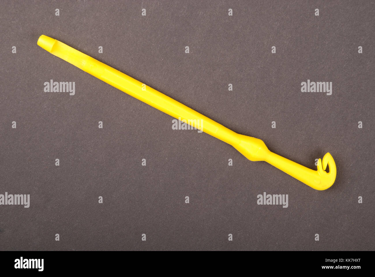 One yellow loop tier isolated on black background Stock Photo - Alamy