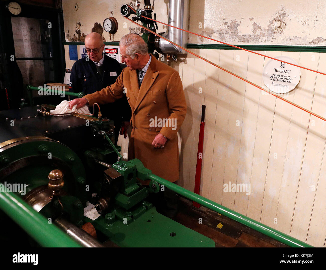 The Prince of Wales polishes a restored steam engine during a visit to ...