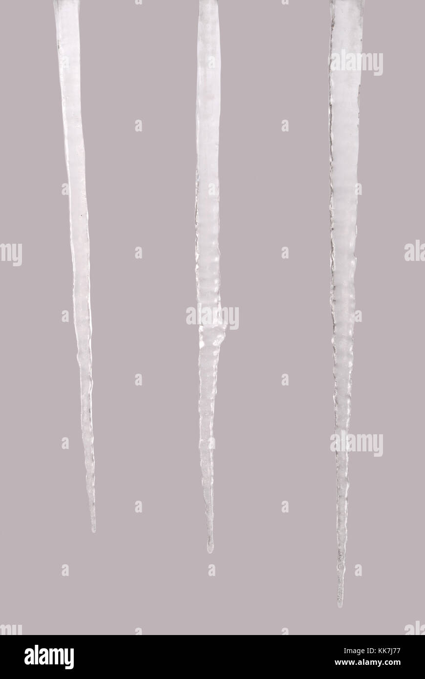 Icicles isolated on a grey background. Frozen water. Three clipping ...