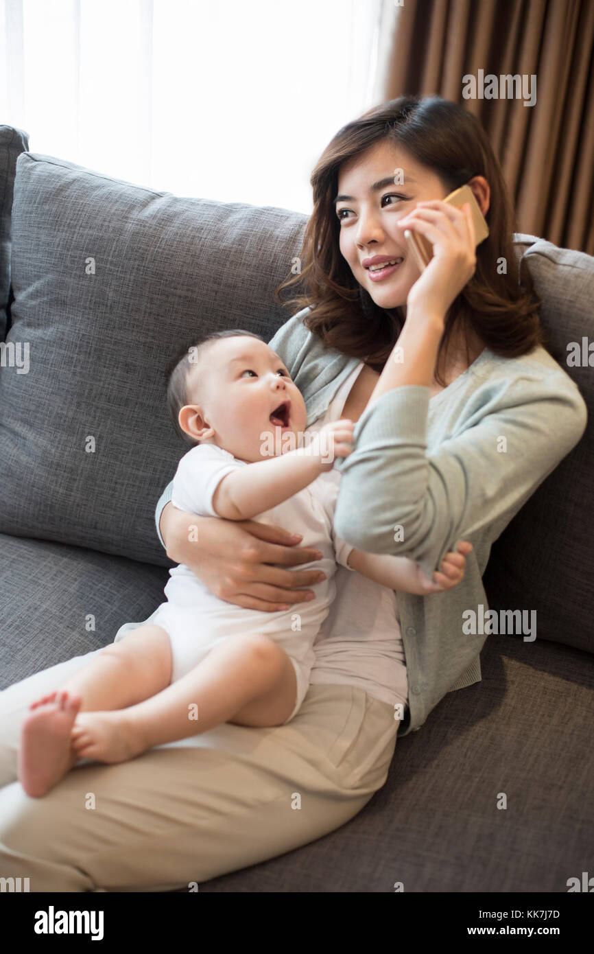 Happy Chinese mother and cute baby at home Stock Photo - Alamy