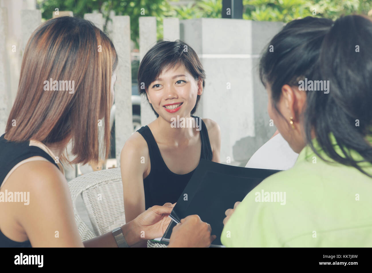 younger asian woman friend talking with relaxing at home living terrace ...