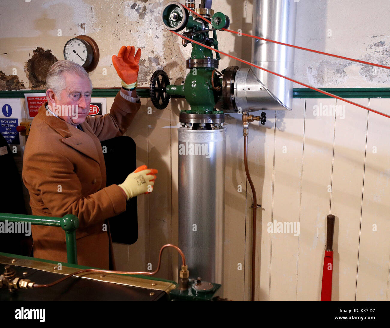 The Prince of Wales starts a restored steam engine during a visit to ...