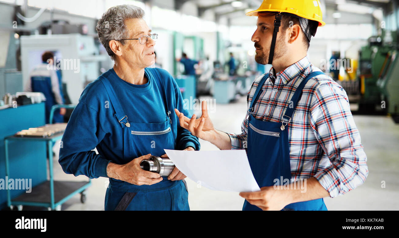 Team Of Engineers Having Discussion In Factory Stock Photo - Alamy