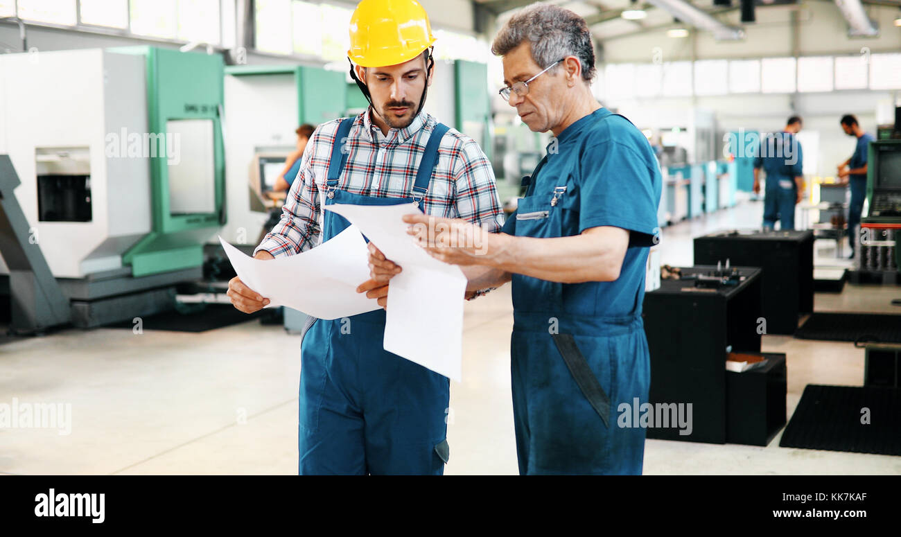 Team Of Engineers Having Discussion In Factory Stock Photo - Alamy