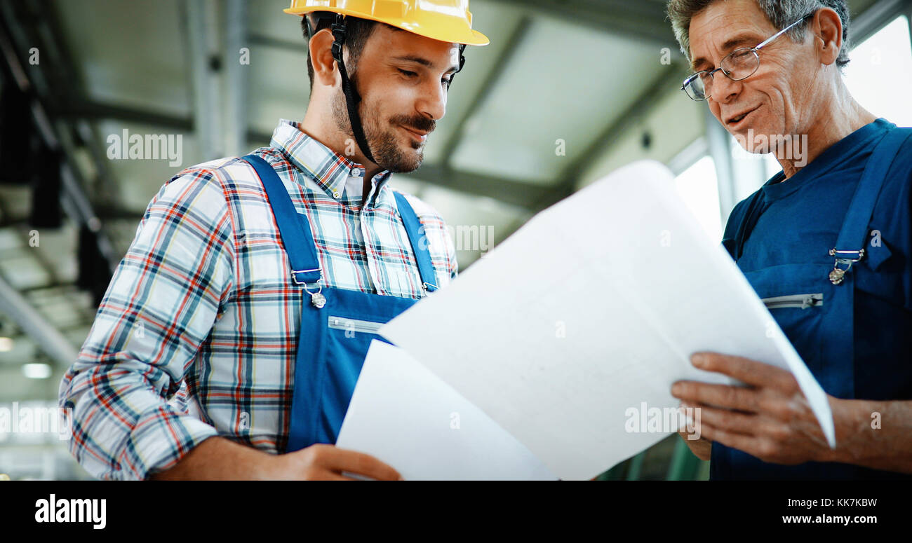 Team Of Engineers Having Discussion In Factory Stock Photo - Alamy