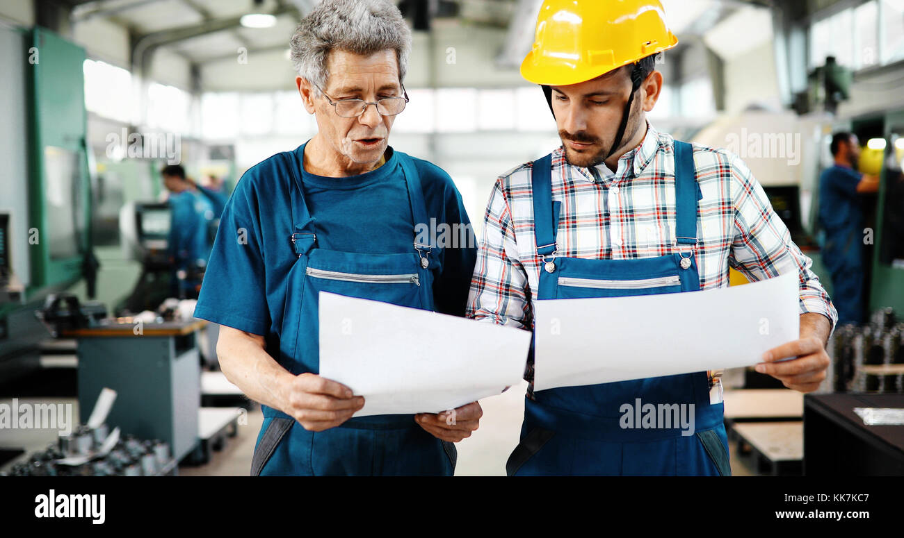 Team Of Engineers Having Discussion In Factory Stock Photo - Alamy